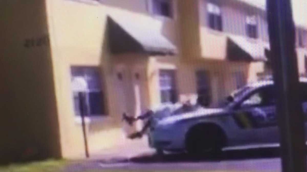 Video shows man throwing himself into police car Video shows man throwing himself into police car
