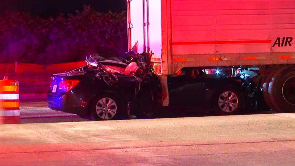 Half of car crushed under semi-truck in deadly wreck